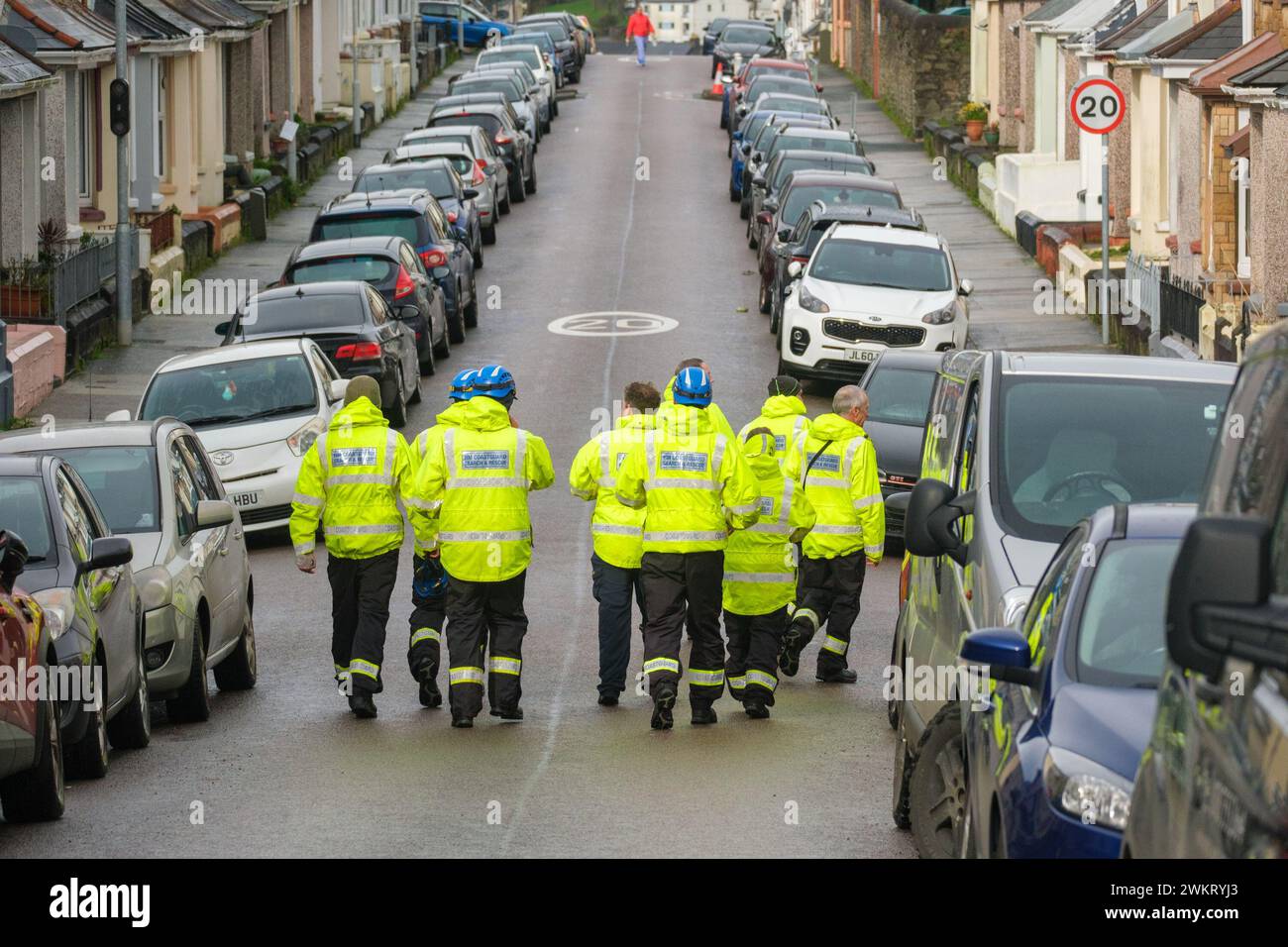 Members of HM Coastguard Search and Rescue walk along a road after ...