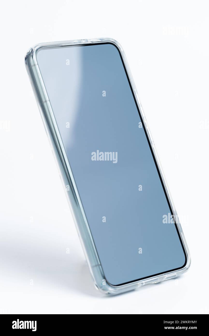 Standing vertical smartphone with blank screen isolated on white studio ...