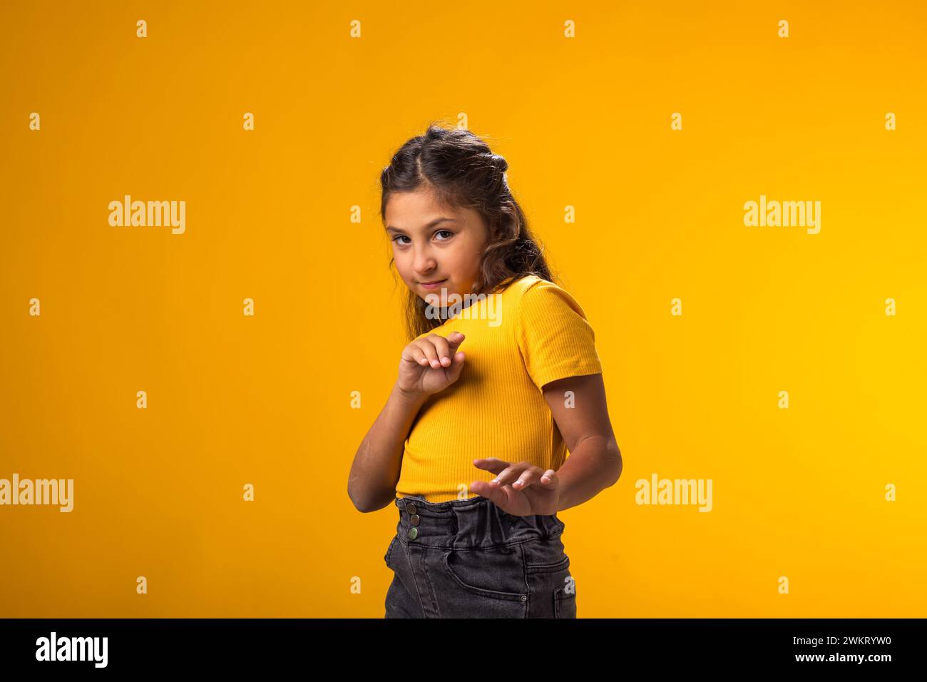 Scared girlwearing yellow t-short showing disgust gesture with hands ...