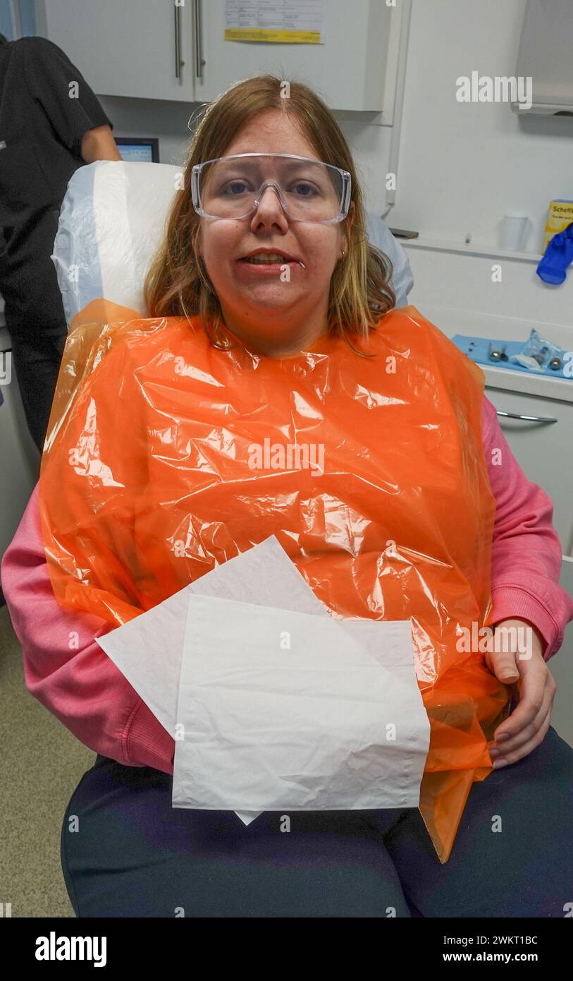 female patient in the dentists chair have an extraction of two wisdom ...