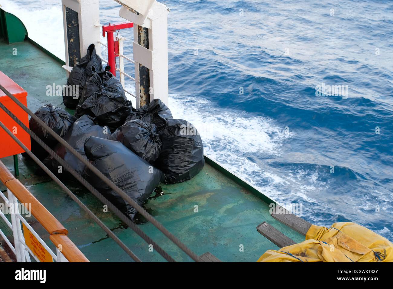 Black trash bag on the green floor of a cruise ship during a cruise ...