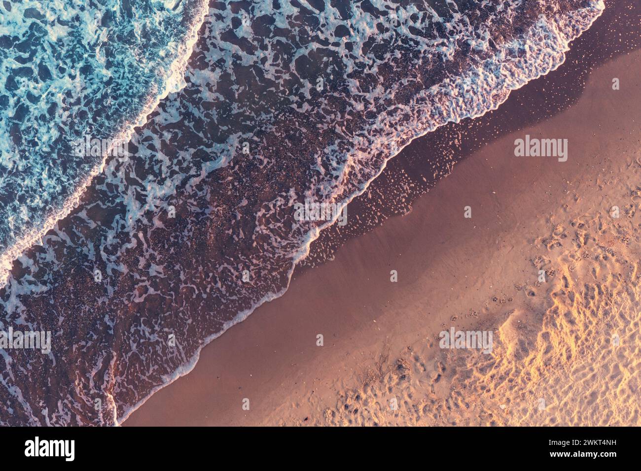 Top view of the surf lie. Waves and sandy beach. Artistic red-green ...