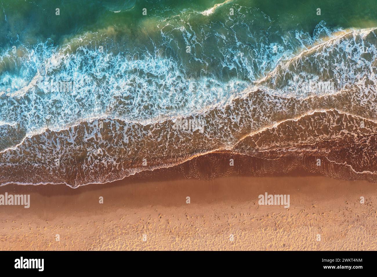 Top view of the surf lie. Waves and sandy beach. Artistic red-green ...