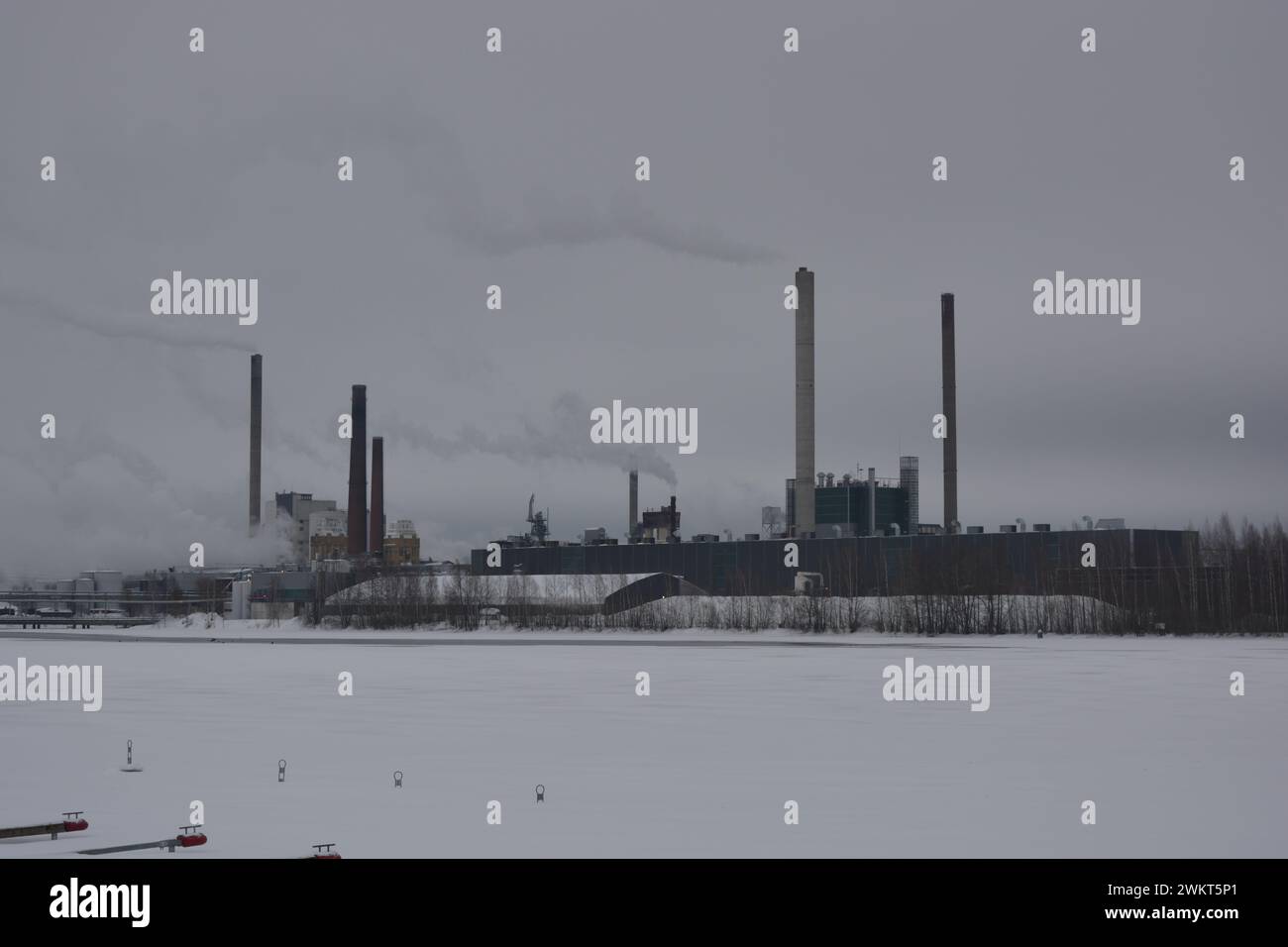 An industrial plant, a processing plant with large chimneys from which ...