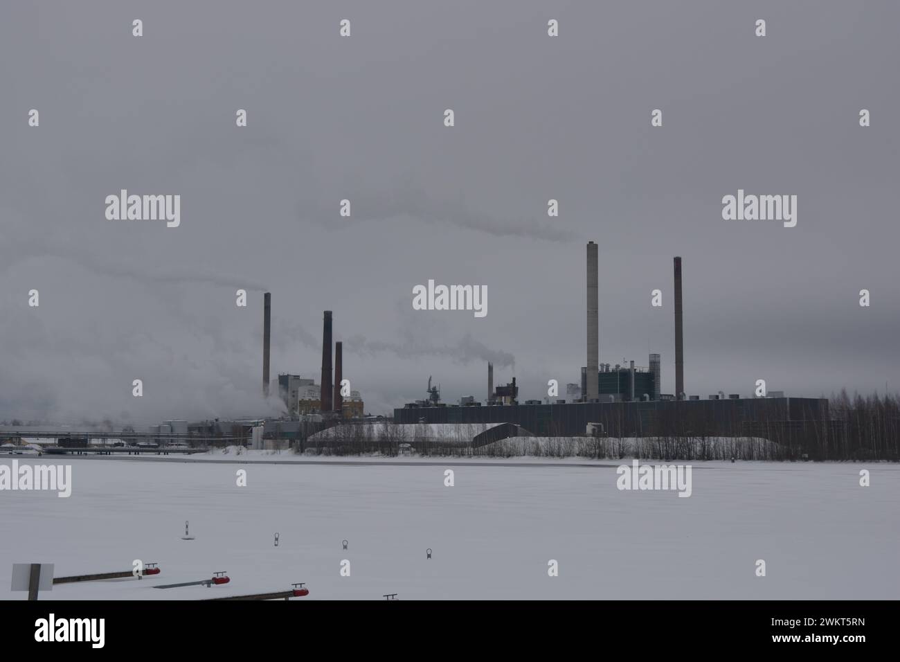 An industrial plant, a processing plant with large chimneys from which ...