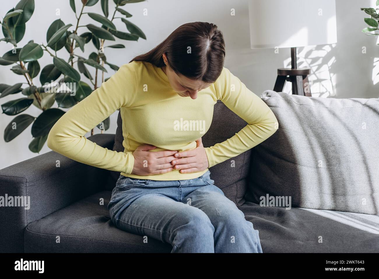 Close up of upset young woman suffering from menstrual pain. Girl with ...