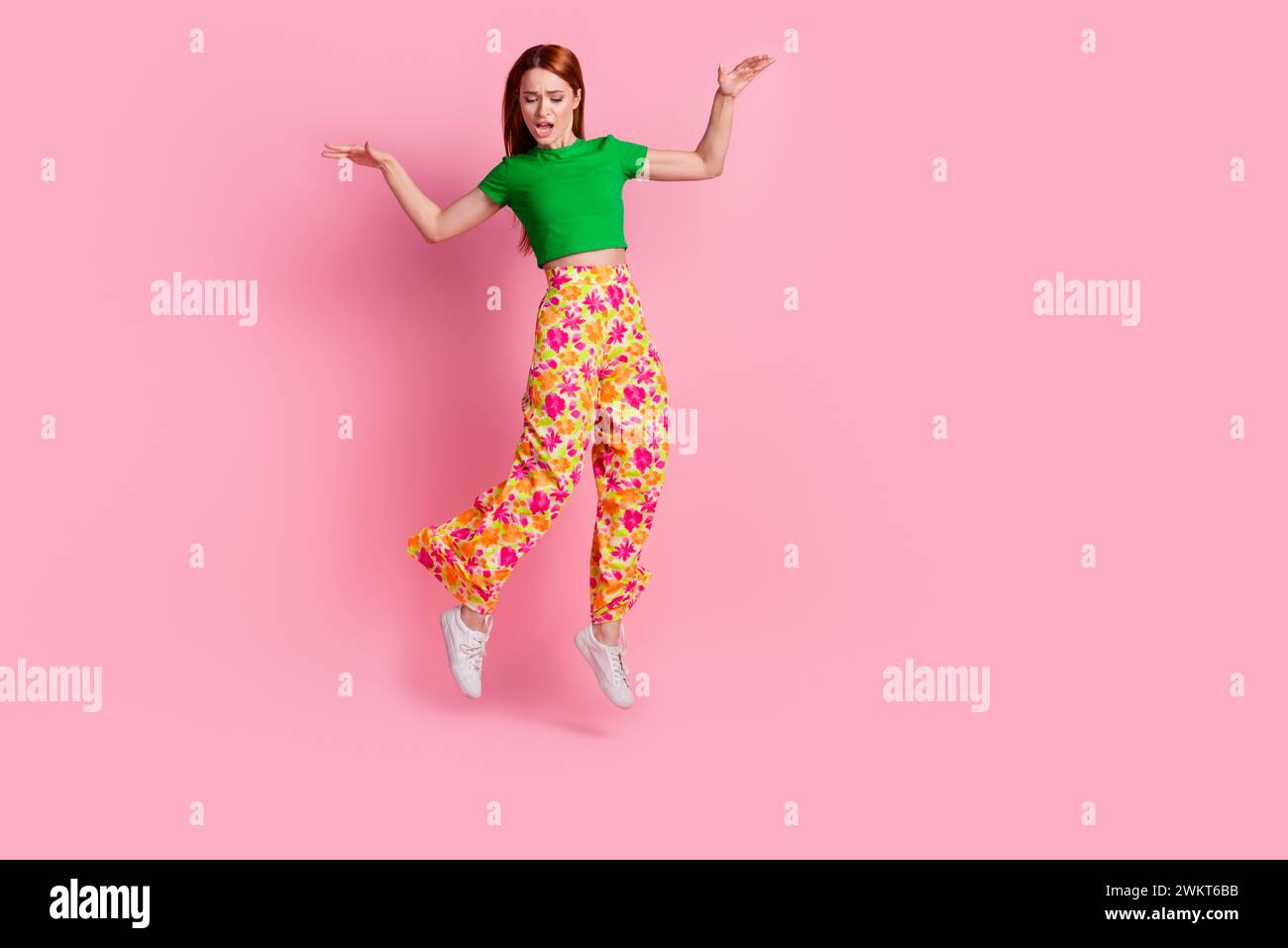 Full length photo of impressed woman dressed green t-shirt falling in ...