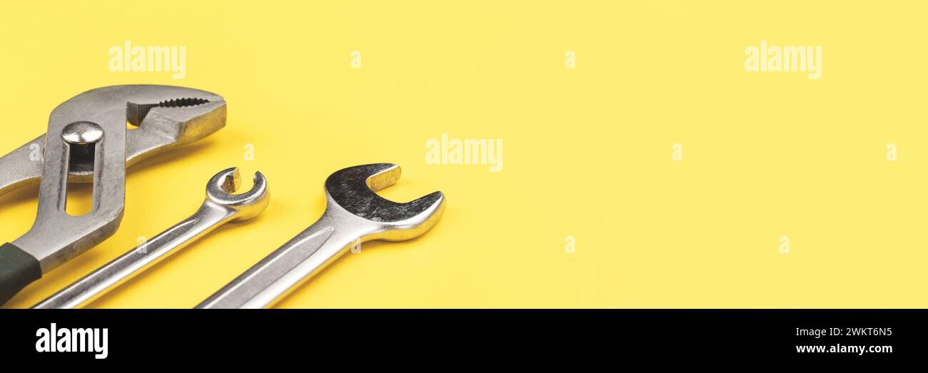 Work tools on bright yellow background banner. Panoramic web header ...