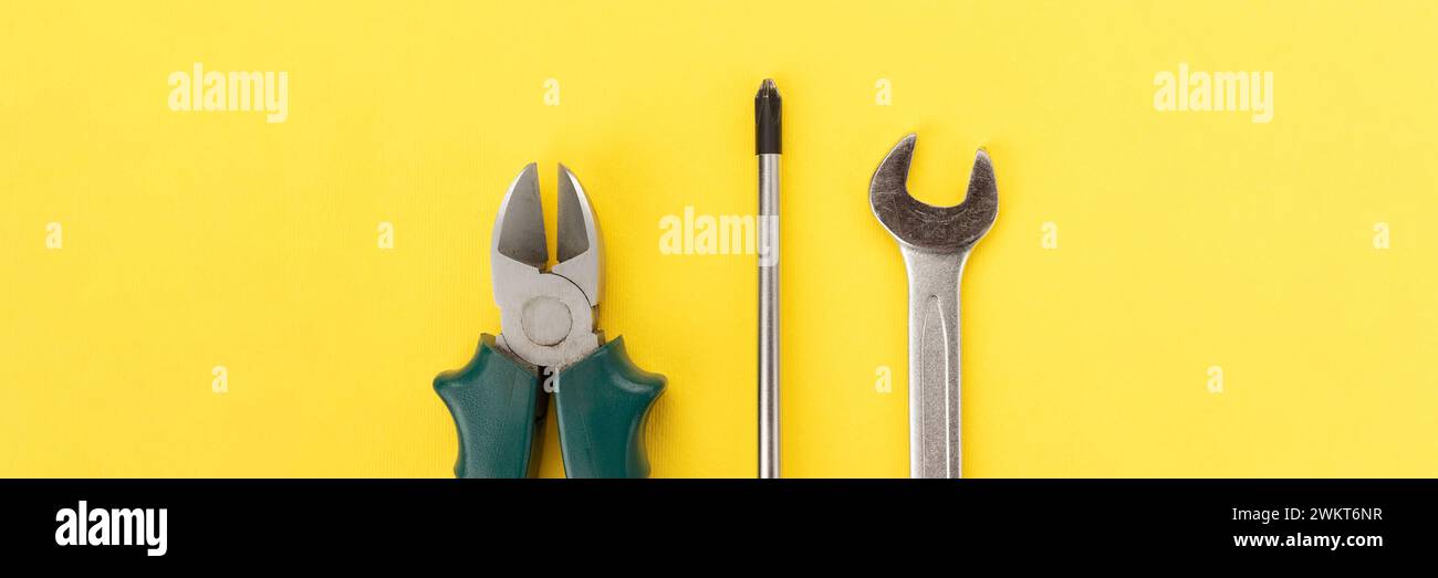Work tools on bright yellow background banner. Panoramic web header ...