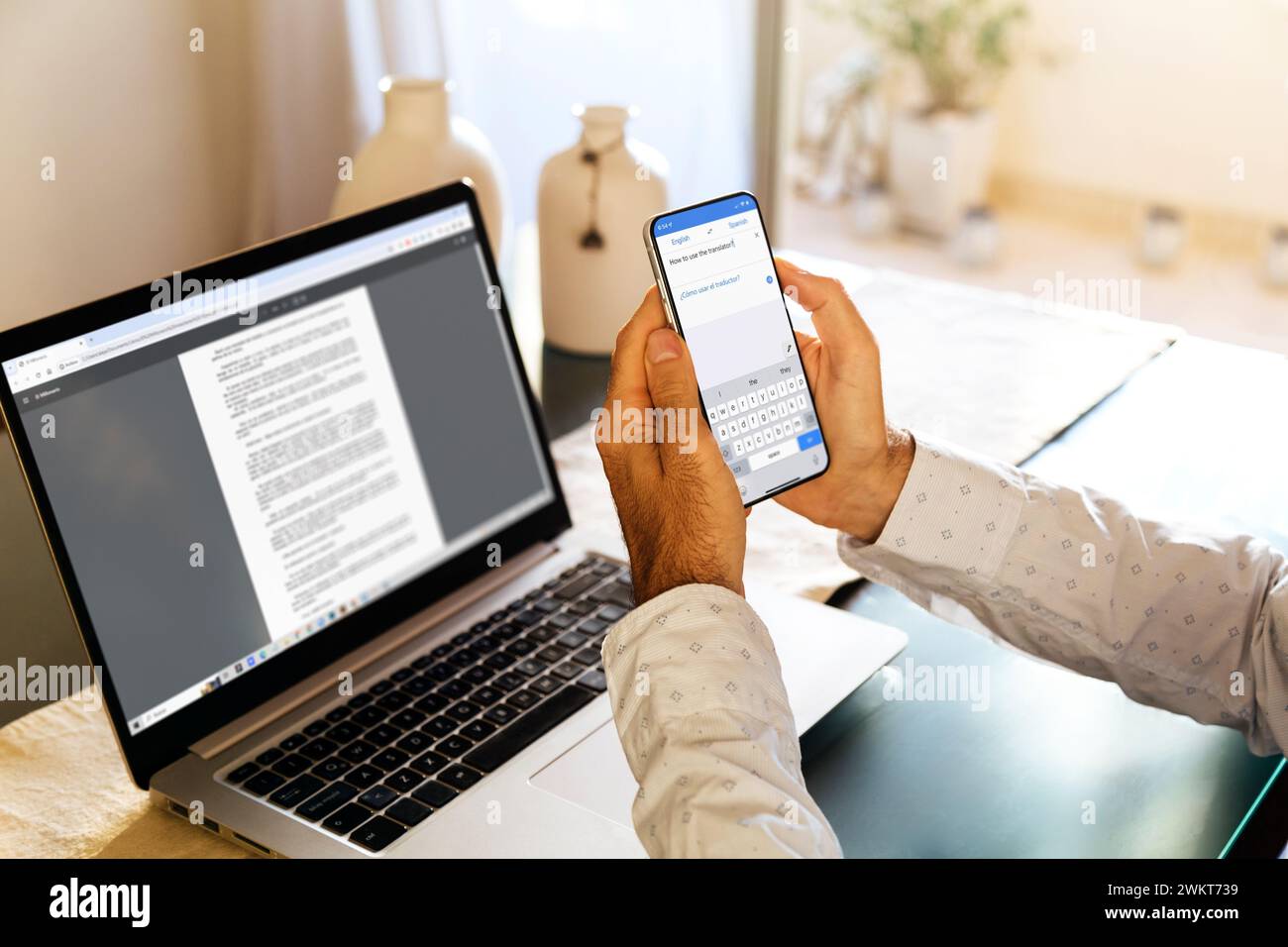 Man using Google Translate application in a smartphone. He is at home ...