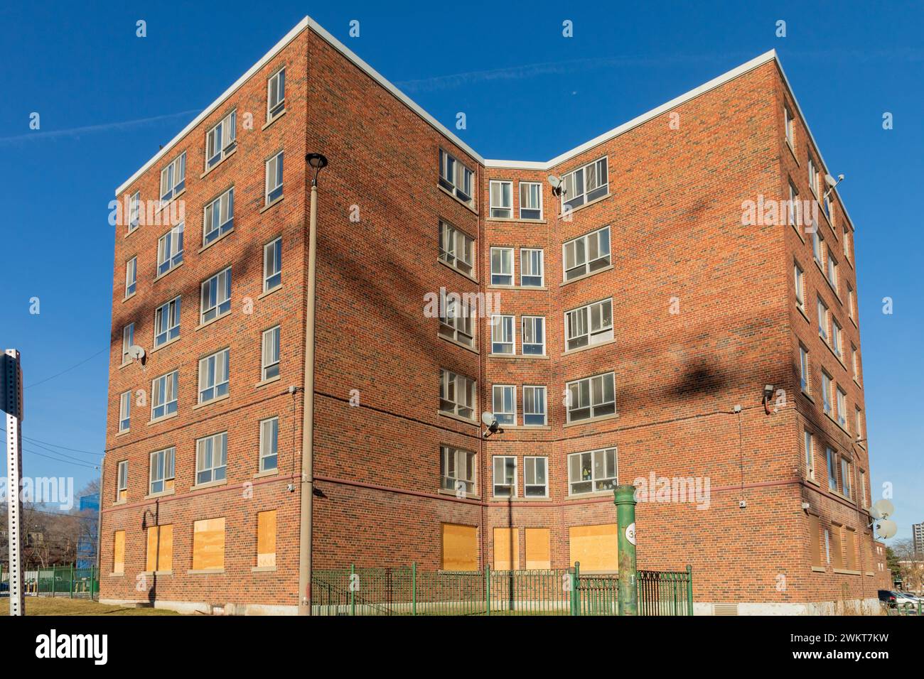 A partly boarded up apartment building still shows signs of family life ...