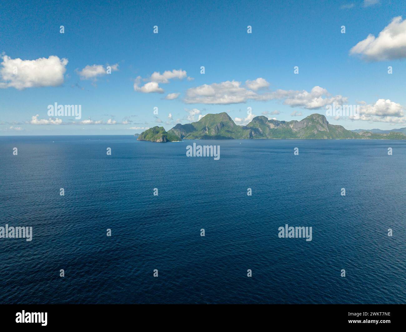 Helicopter Island and Cadlao Island with blue sea. Blue sky and clouds ...