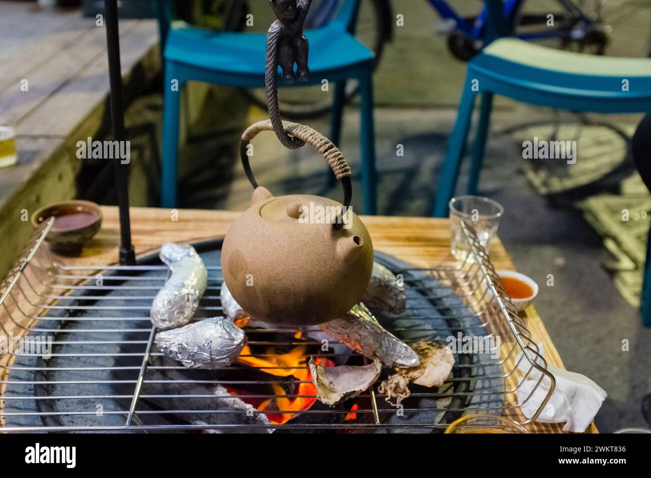 Clay pot kettle over a open pit fire during winter Stock Photo - Alamy