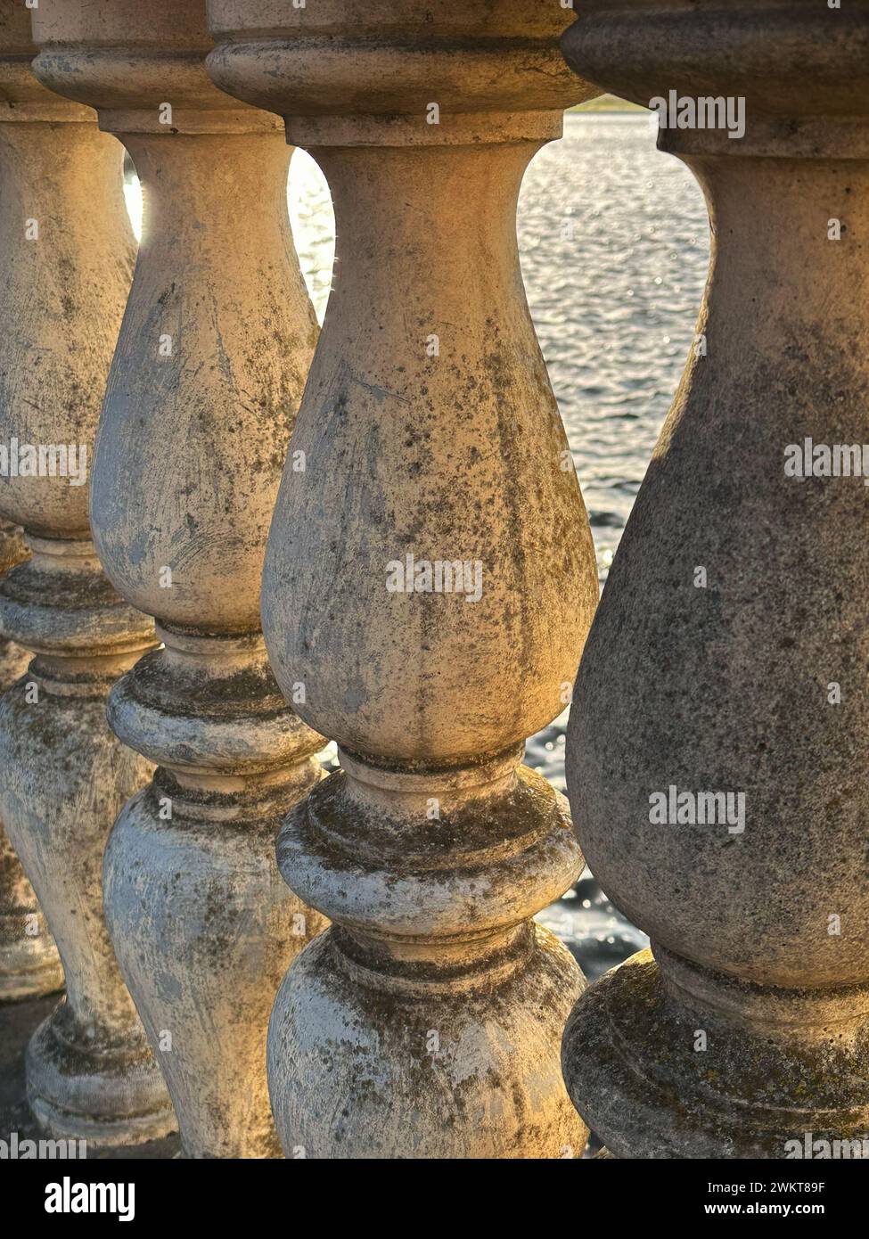 old ancient balustrade columns with water in background Stock Photo - Alamy
