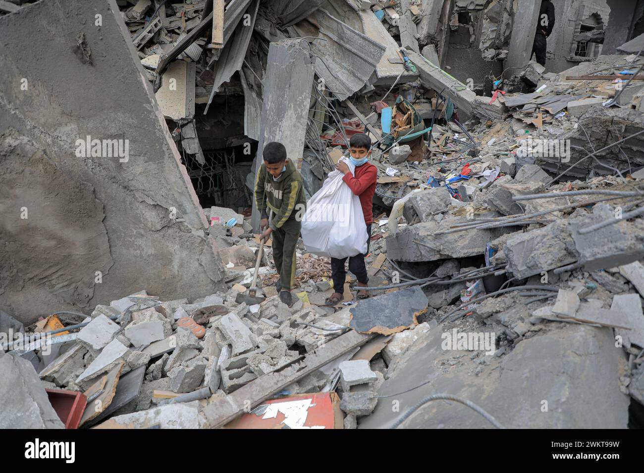 RAFAH, Feb. 22, 2024 (Xinhua) -- Children check the rubble of a ...