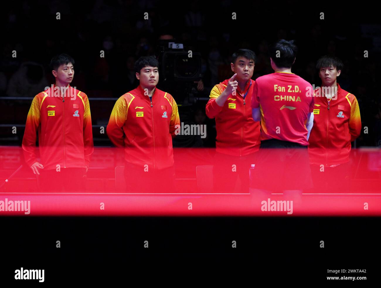 Busan, South Korea. 22nd Feb, 2024. Coach Wang Hao (3rd R) of China talks with Fan Zhendong ...