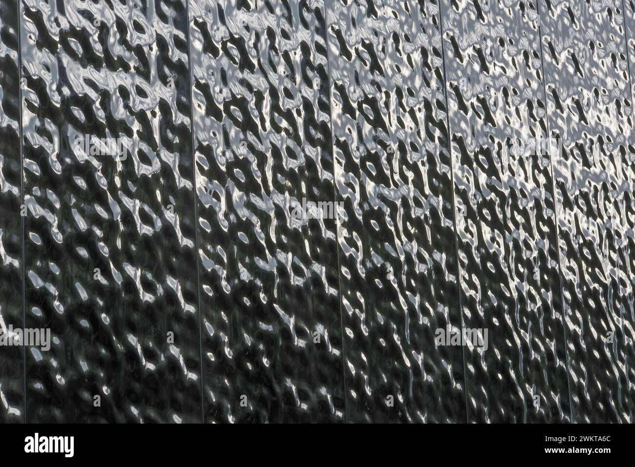 Metal building facades that mimic the texture of rippling water ...