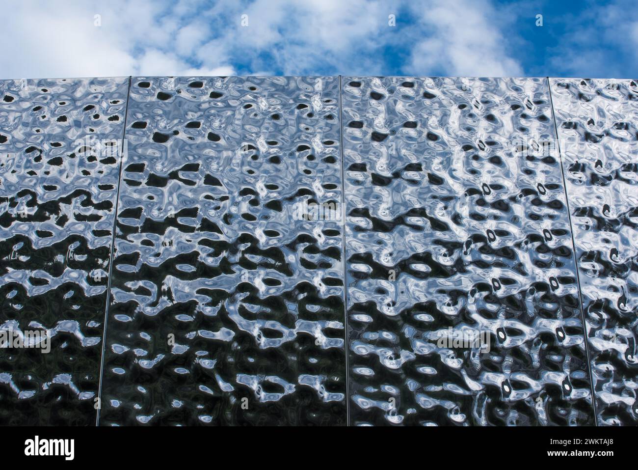 Metal building facades that mimic the texture of rippling water ...