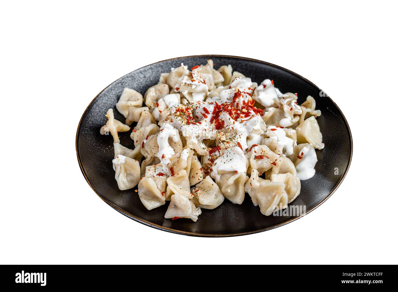 Turkish manti with yoghurt and tomato sauce in a plate. Isolated on ...