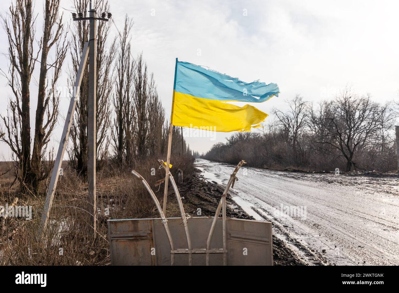 Donetsk Reg., Ukraine. 14th Feb, 2024. A torn but proudly flying flag ...