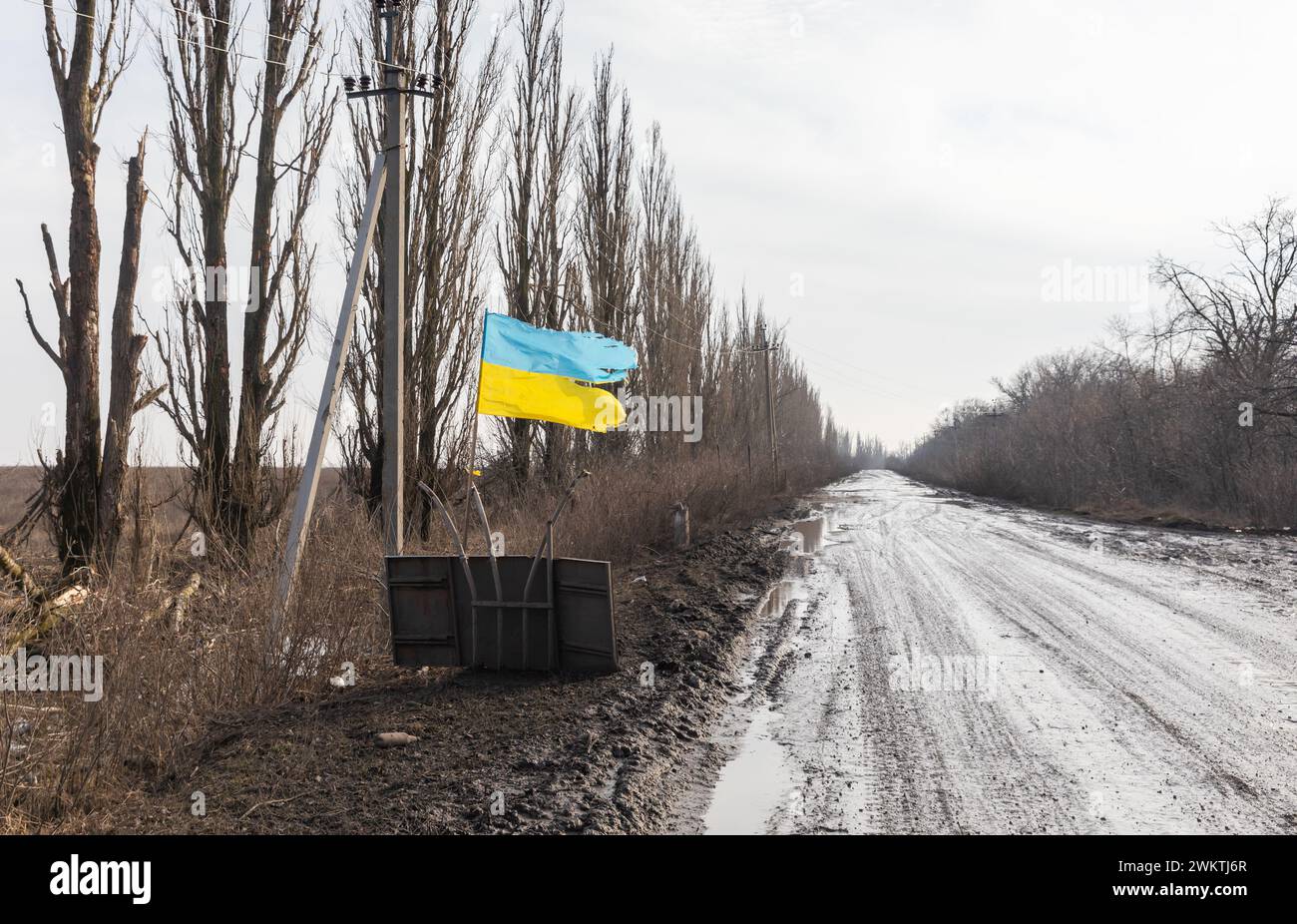 Donetsk Reg, Ukraine. 14th Feb, 2024. A torn but proudly flying flag is ...