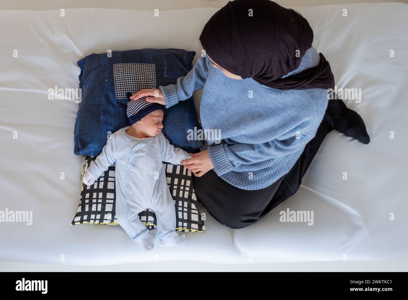 Arabic Muslim parents share a tender moment with their newborn daughter ...