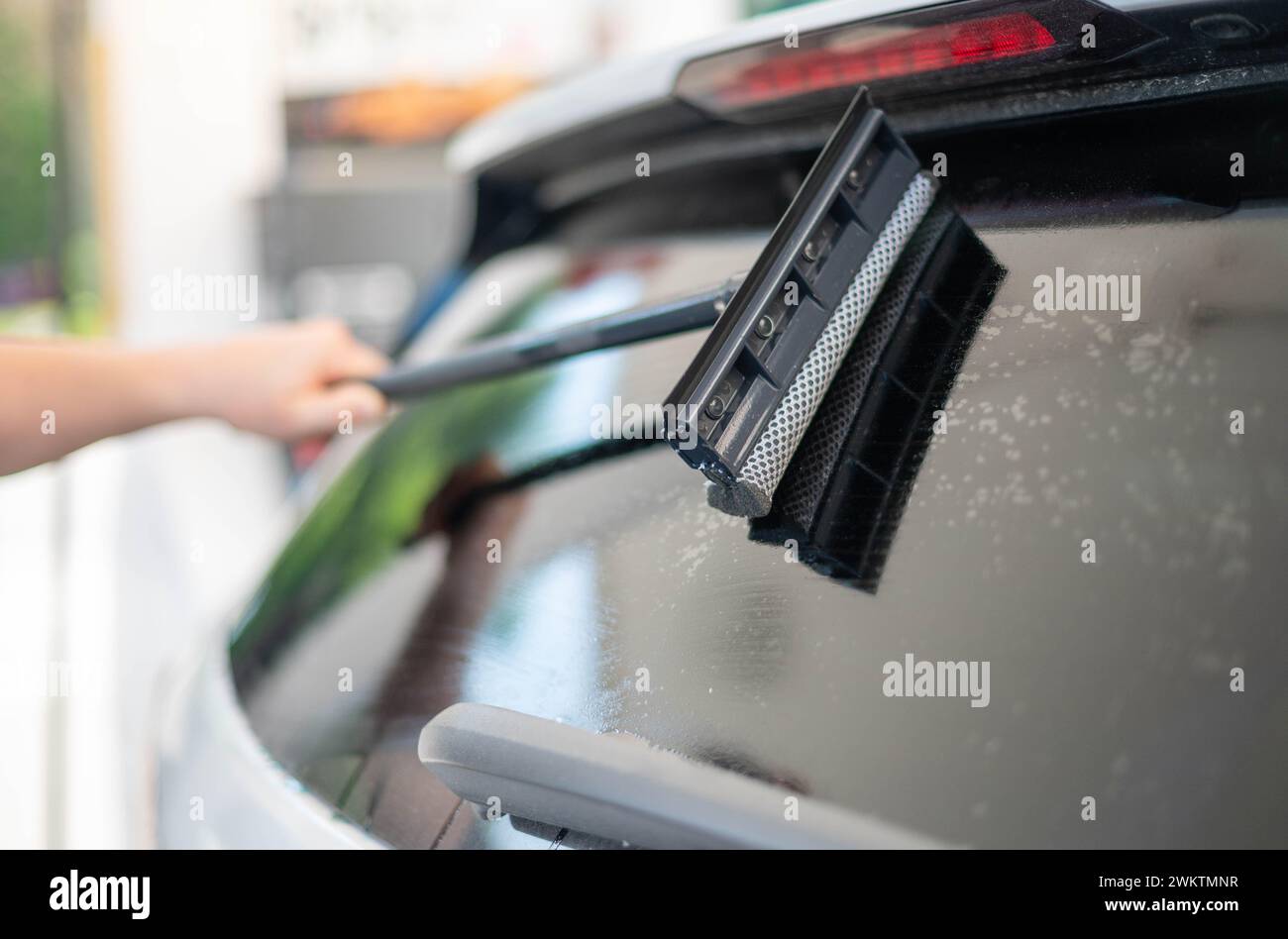 Mature male worker cleaning car windshield with the sponge mop Stock ...