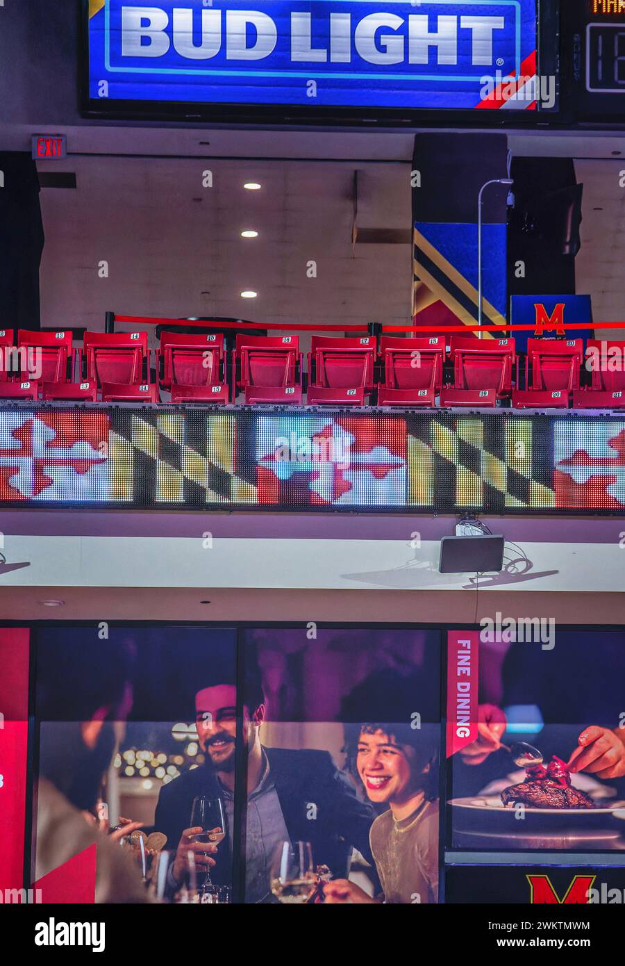 A section of an arena with empty chairs and advertising Stock Photo - Alamy