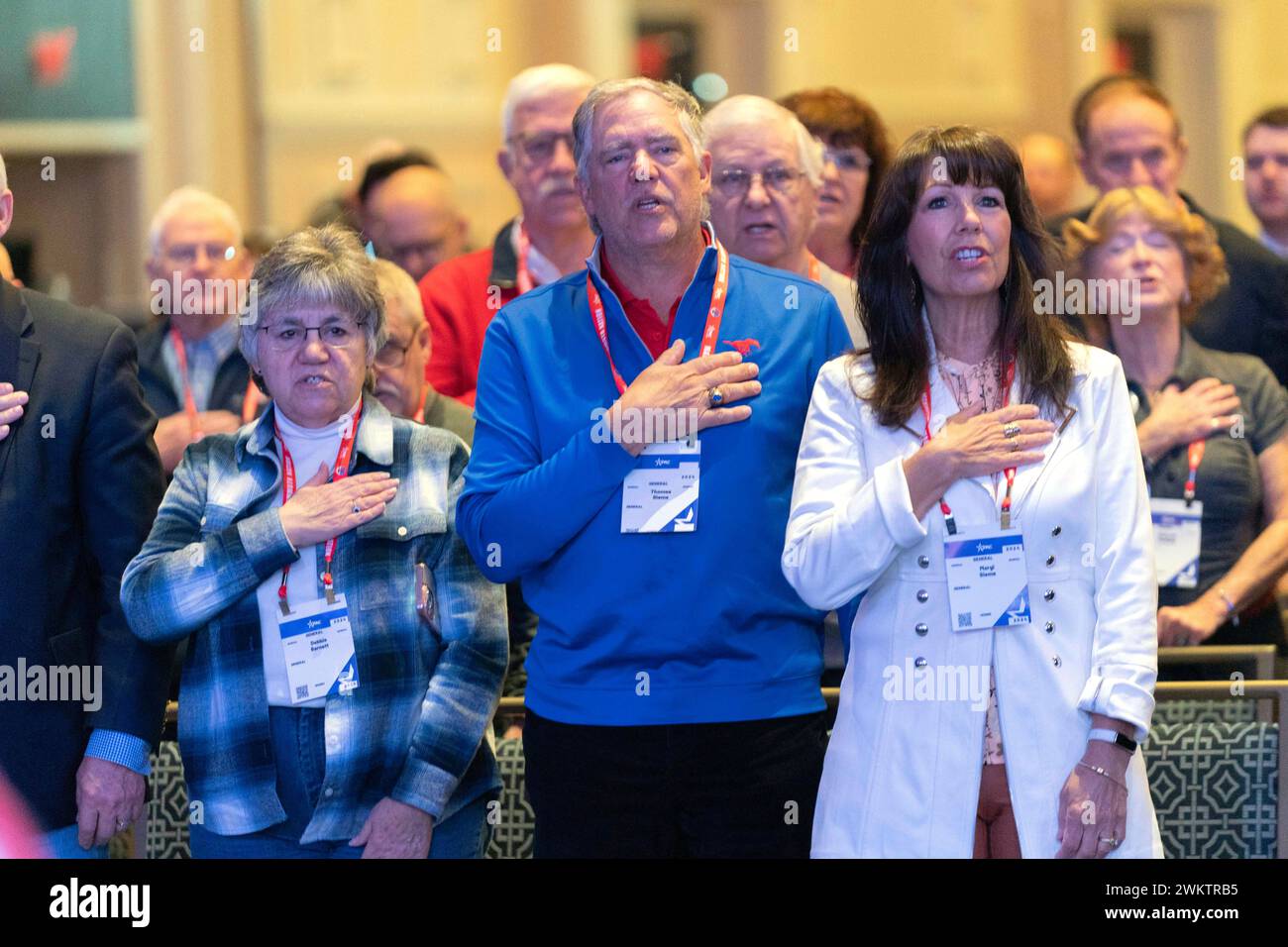 Attendees sing the national anthem during the opening ceremony of the ...
