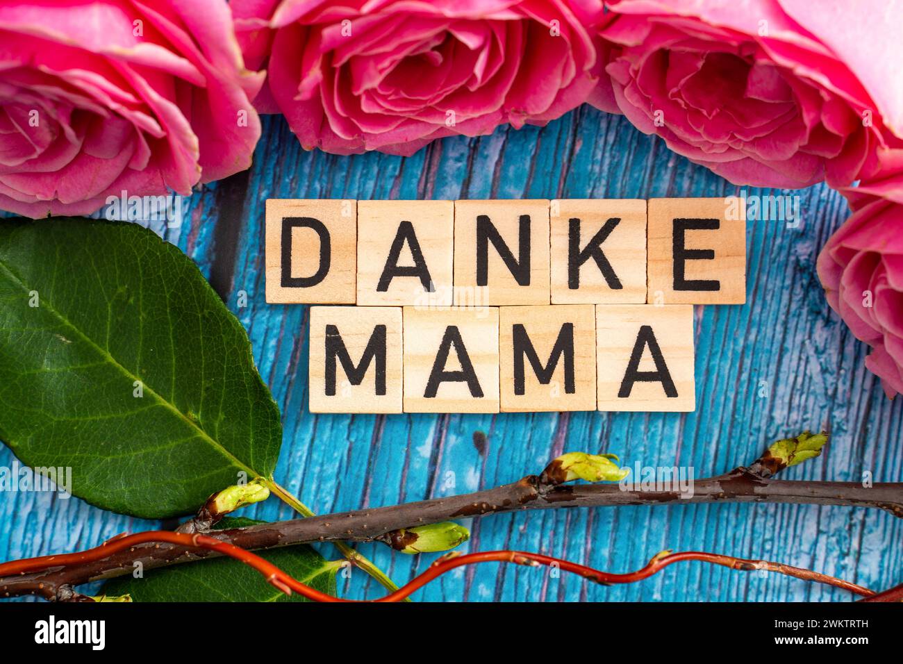 February 21, 2024: Thank you mom Greeting on wooden cubes next to pink ...