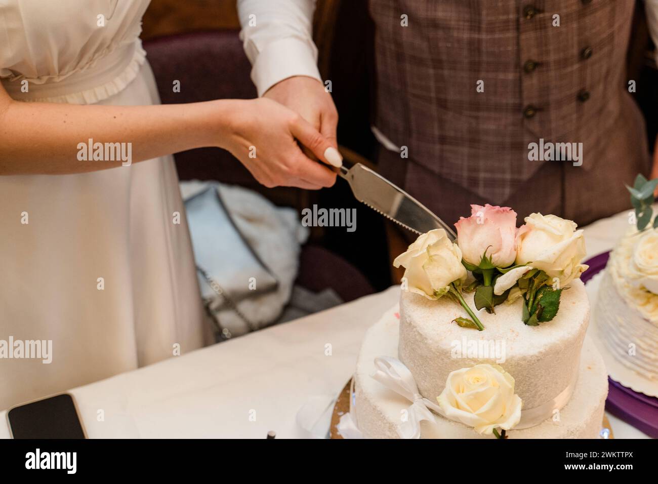 Augsburg, Bavaria, Germany - January 19, 2024: Bride and groom cut the ...