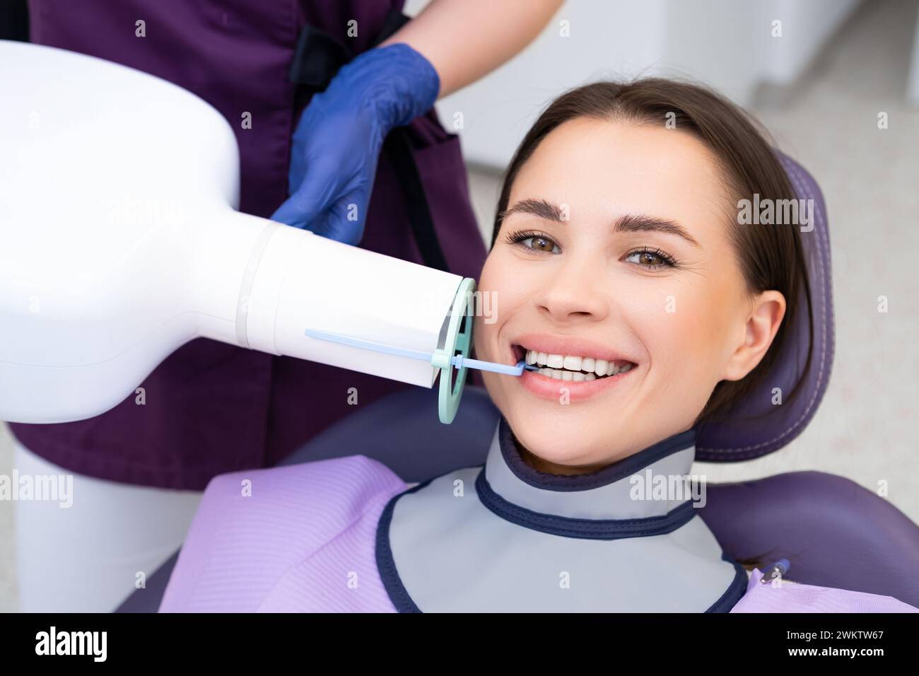 A Female Patient Smiles As She Receives A Teeth X Ray At The Dental