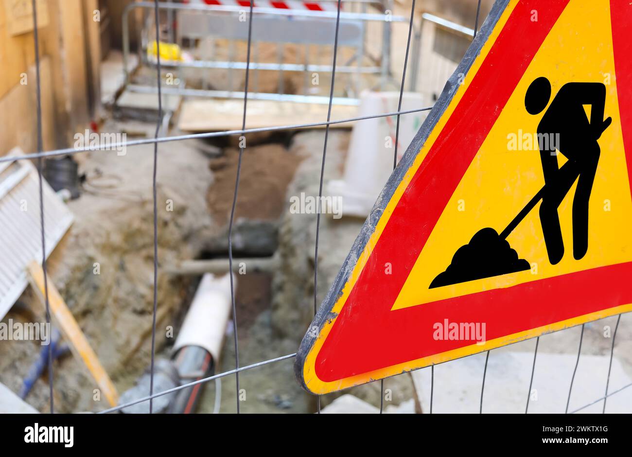 road excavation and the Caution work in progress sign at the construction site Stock Photo - Alamy
