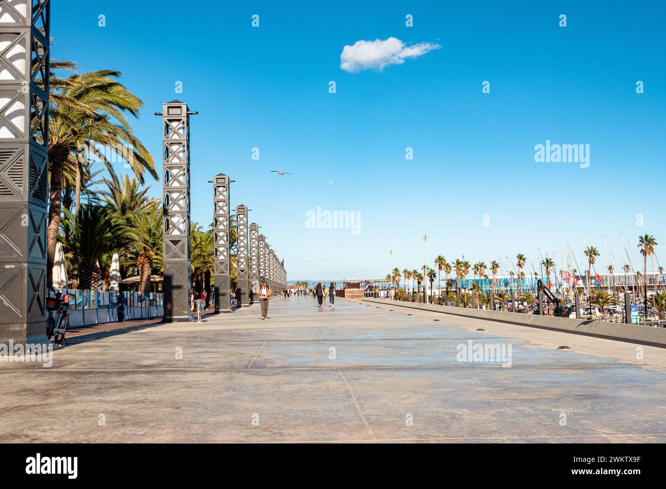 Barcelona, La Barceloneta, people walking, riding bicycles and ...