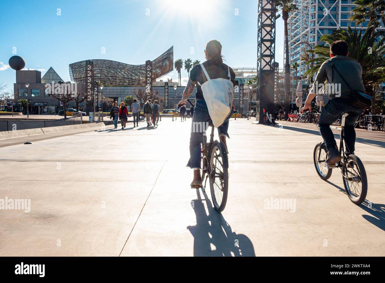 Barcelona, Barceloneta people walking and riding bicycles. Pedestrian ...