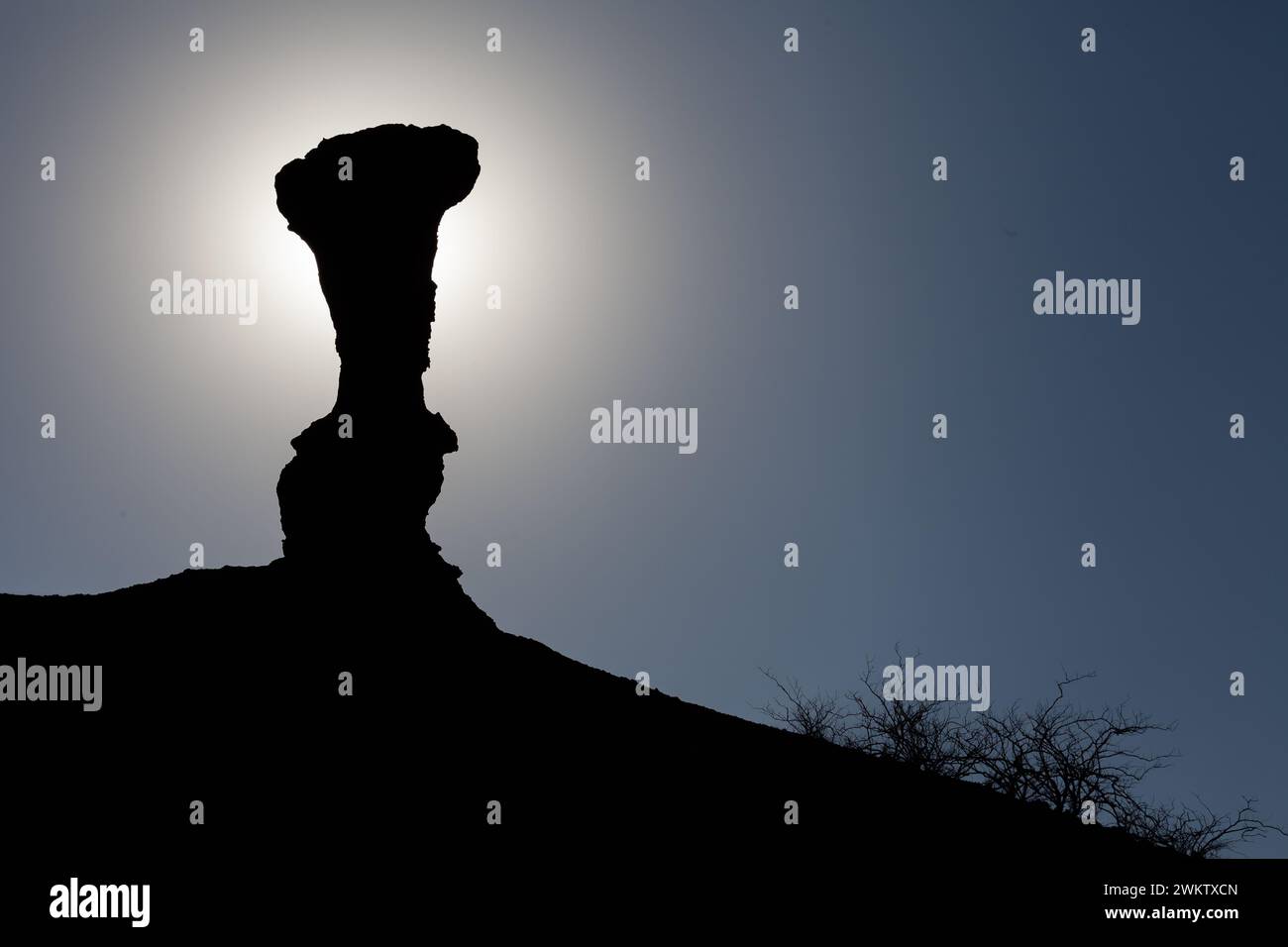Backlit silhouette of a geological formation against the background of ...