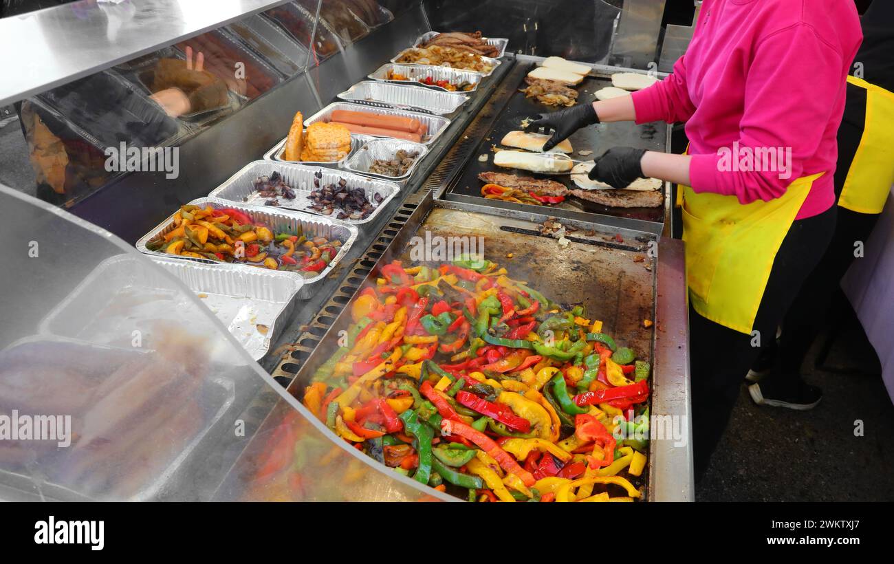 street food truck counter with a sizzling hot griddle preparing ...