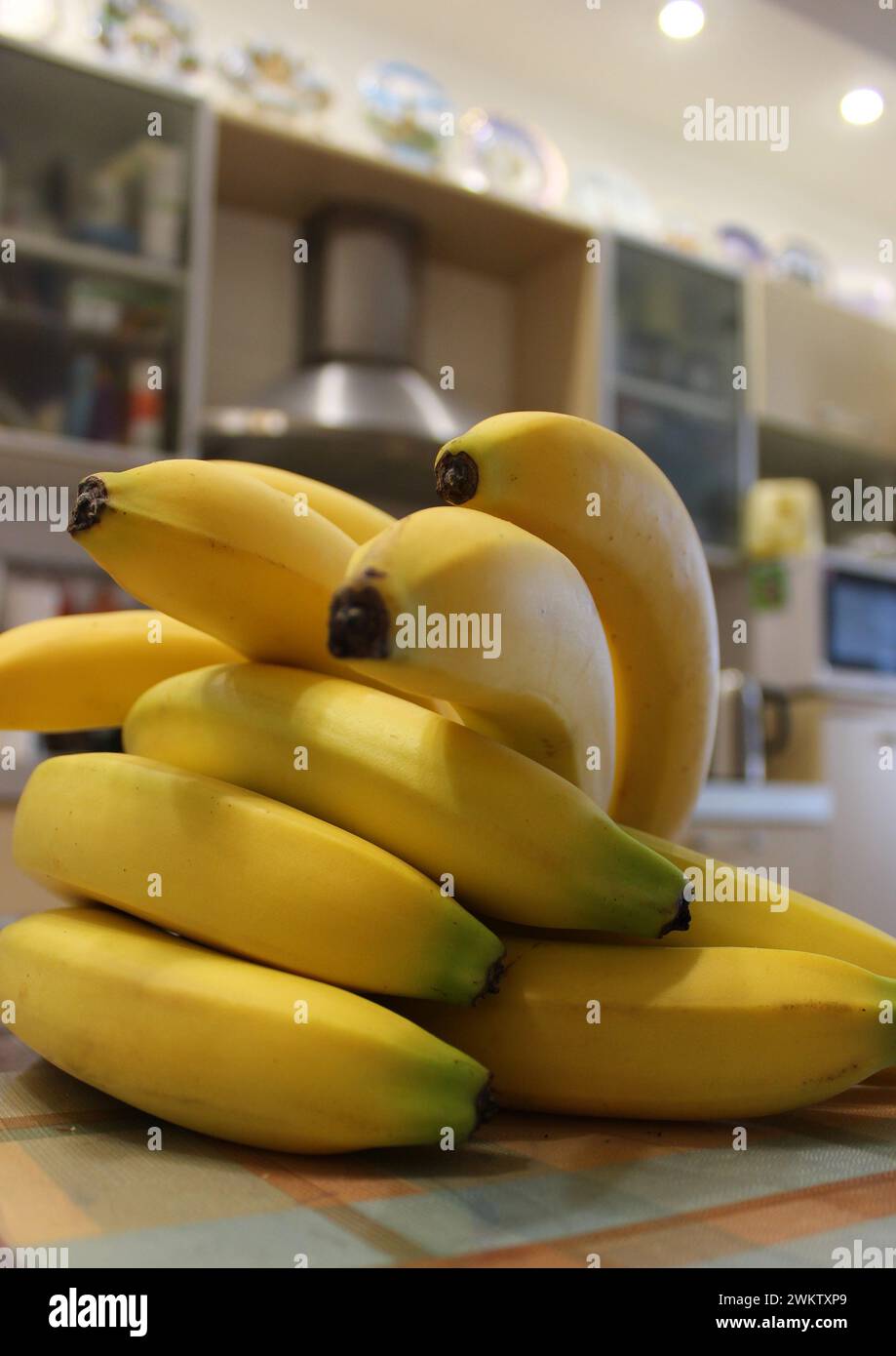 Two bunches of fresh bananas on the table in the kitchen vertical stock ...