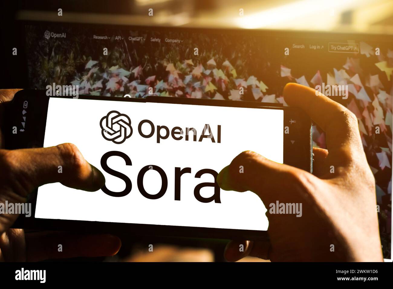 Boy holding smart phone with OpenAI computer logo Description of Sora text-to-video AI model on ...