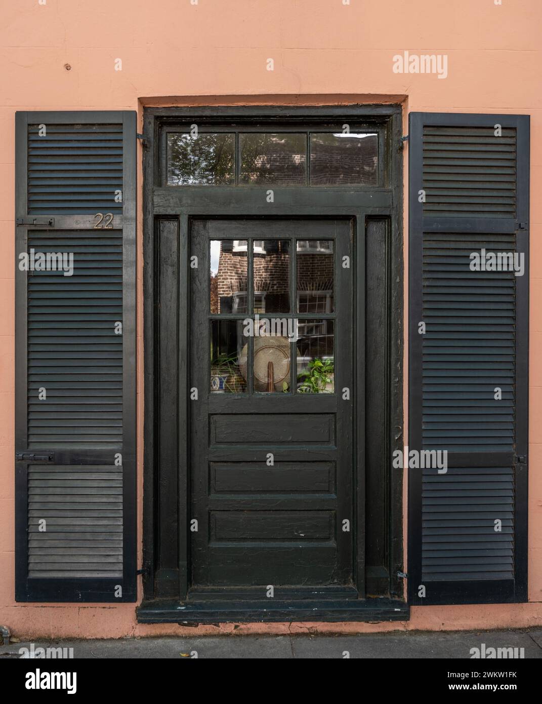 A facade of a building with a window and door beside a sidewalk Stock ...