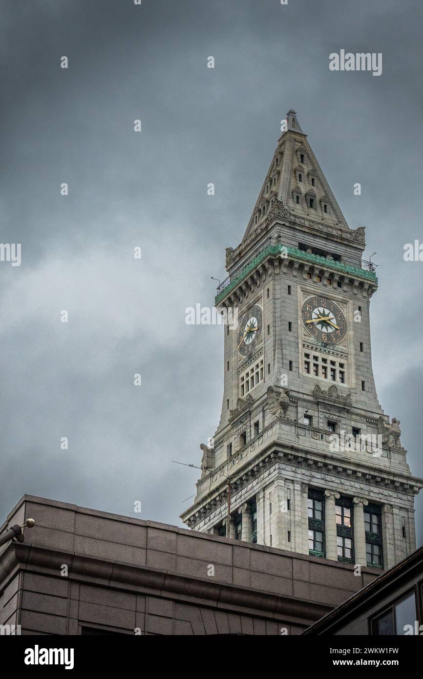 A tall clock tower overlooks a city during the day Stock Photo - Alamy