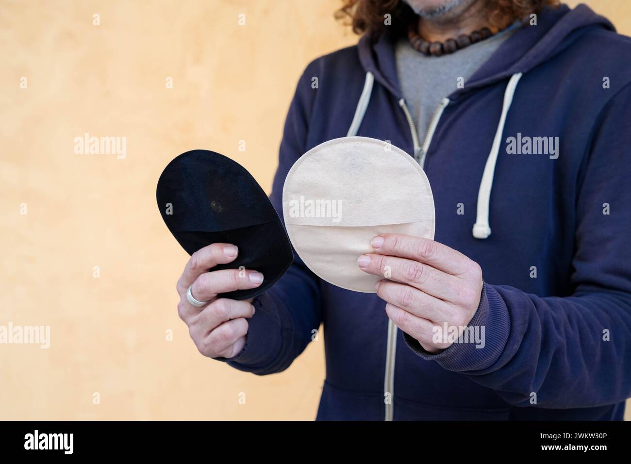unrecognizable person showing ostomy bags. World Colon Cancer Day ...
