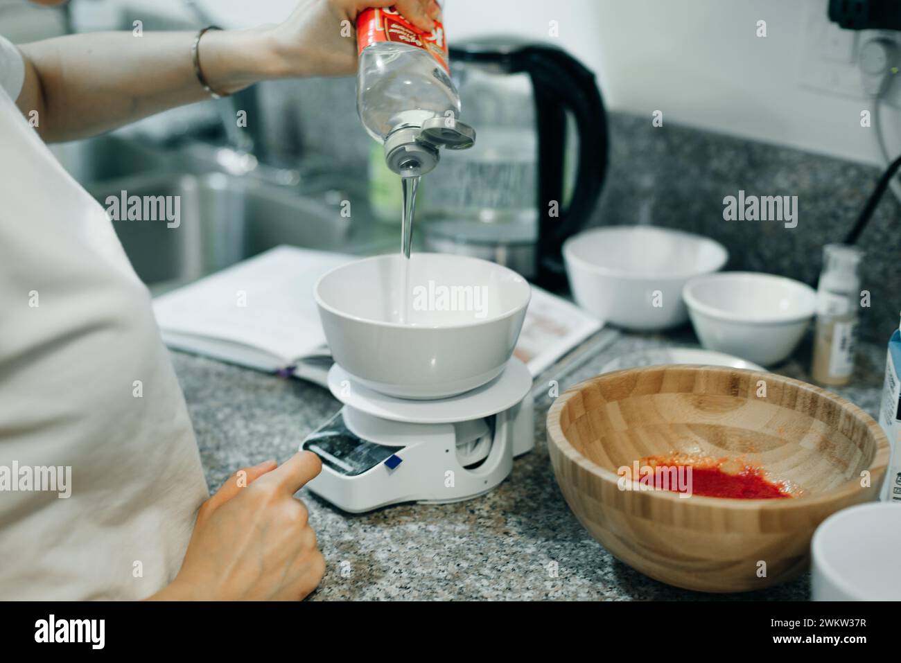 Woman weighing flour on kitchen scale for making cake at home. High ...
