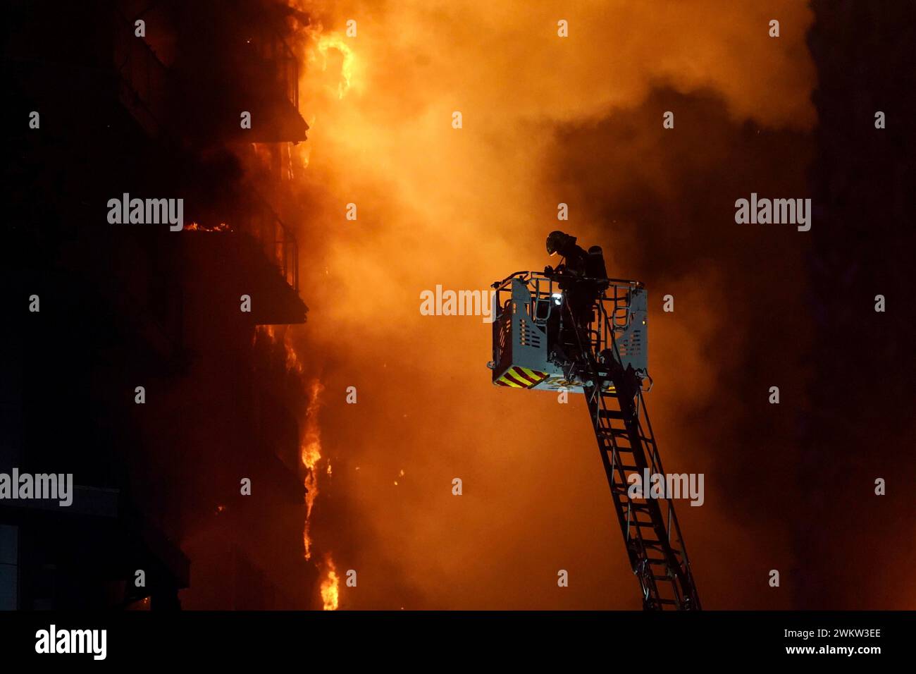 A firefighter tries to extinguish the burning building in the Campanar ...