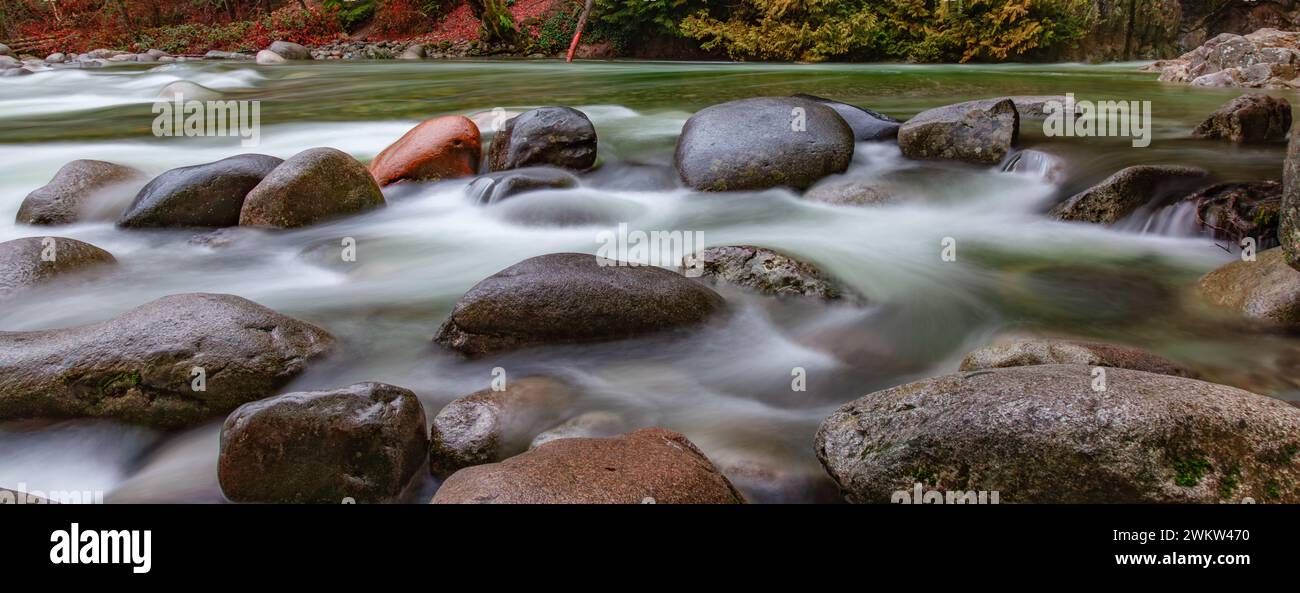 Fresh Water flowing around smooth rocks in Canadian Nature Landscape ...
