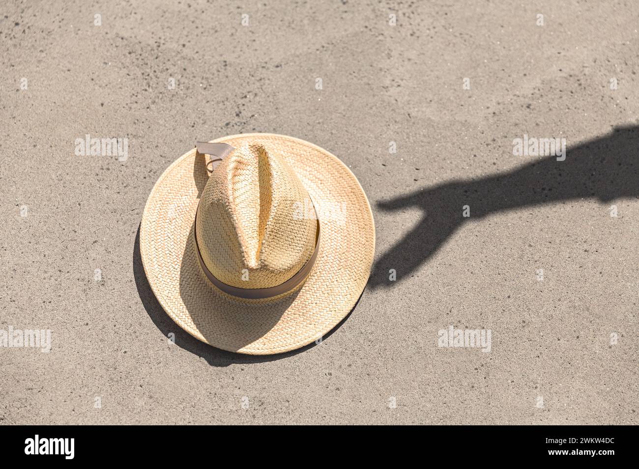 shadow of hand touching real straw hat Stock Photo - Alamy