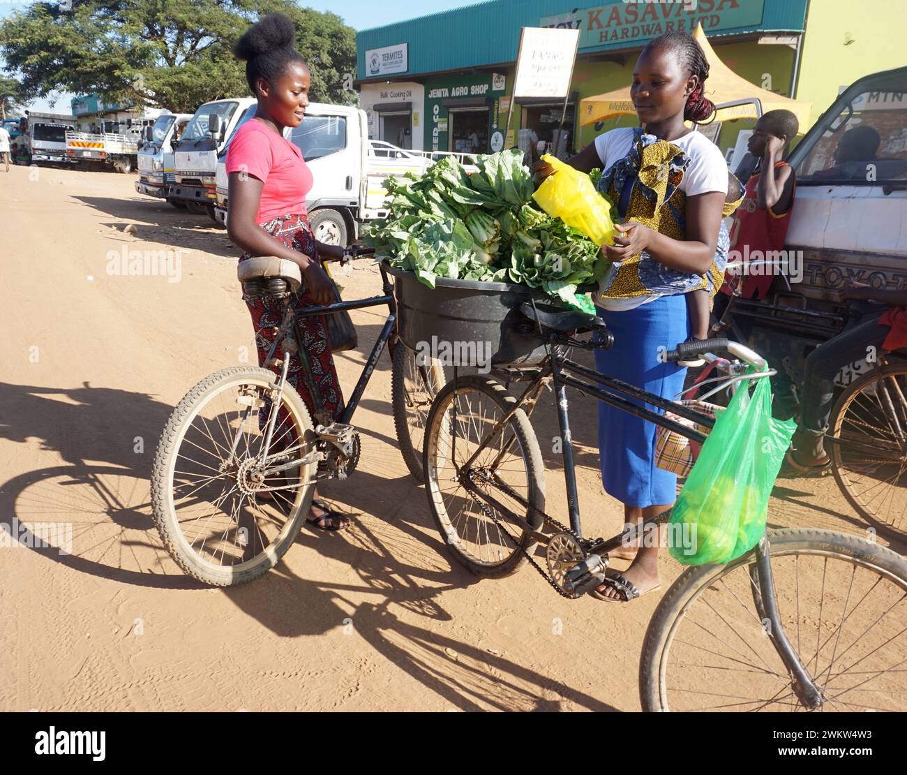 Mpongwe, Zambia. 16th Feb, 2024. Women use bicycles as a means of ...