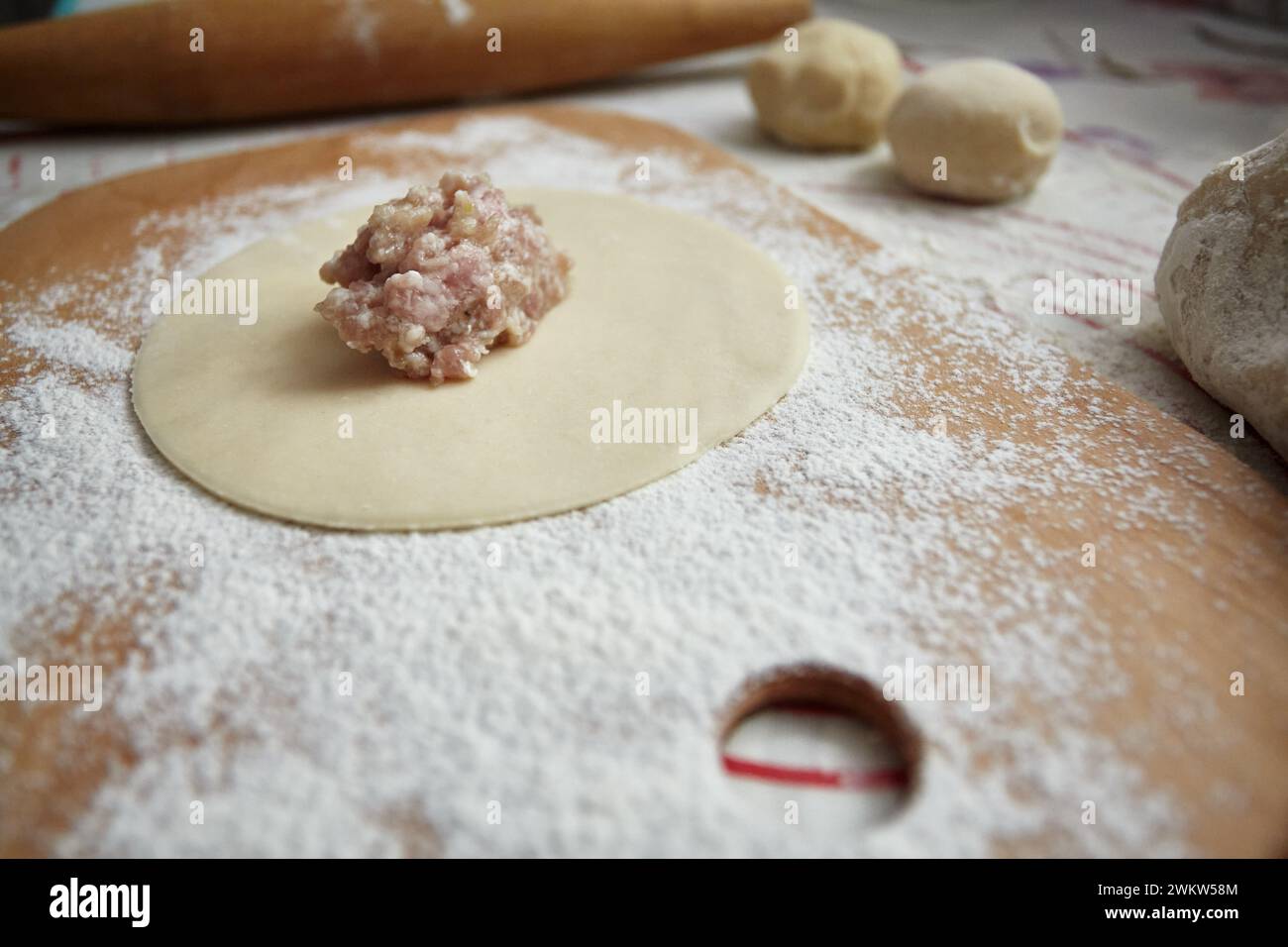 The filling for cheburek is laid out in a flattened layer Stock Photo ...