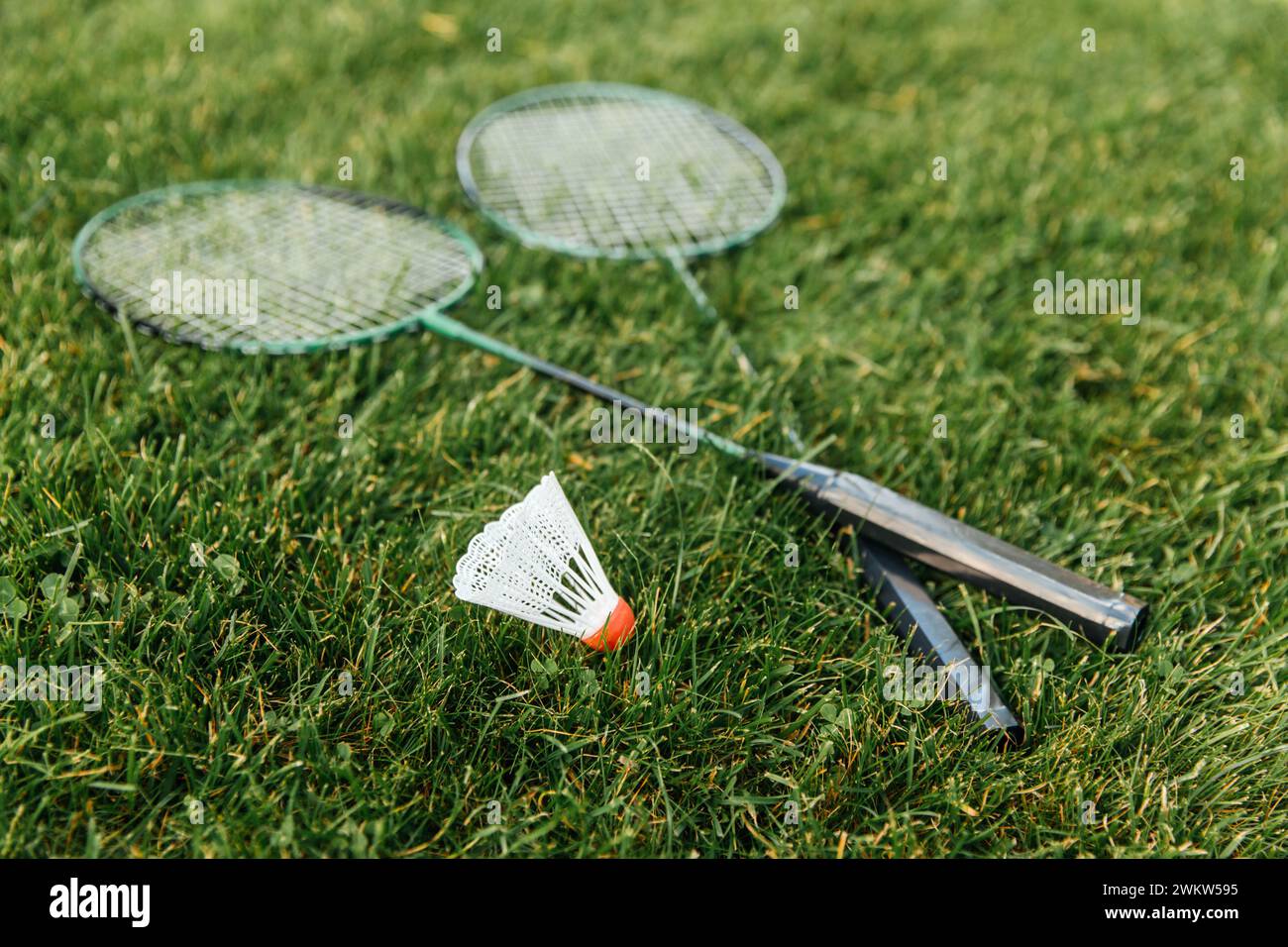 badminton rackets and shuttlecock on grass Stock Photo - Alamy