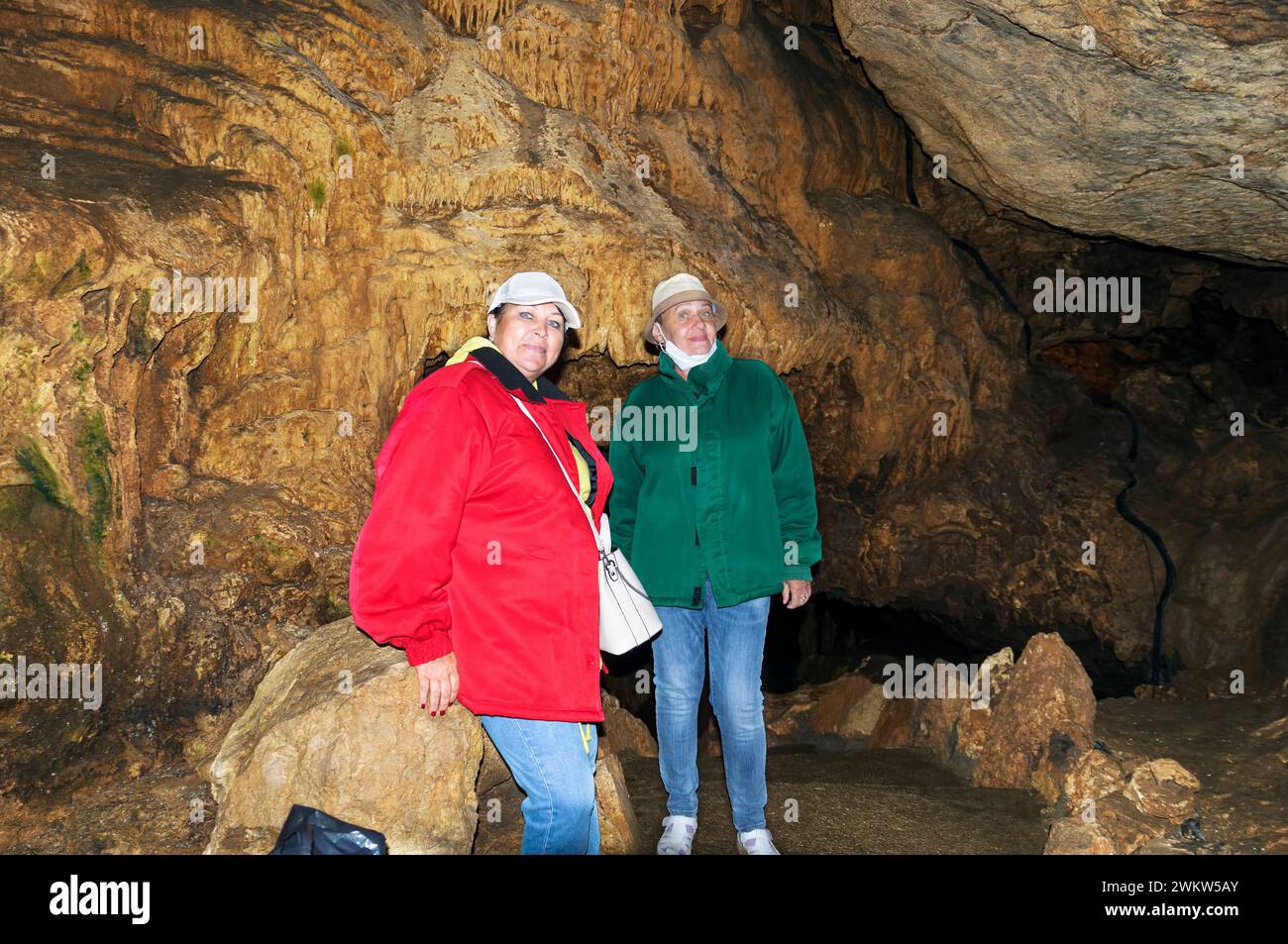 Two women, members of the tourist group, pose against the backdrop of ...